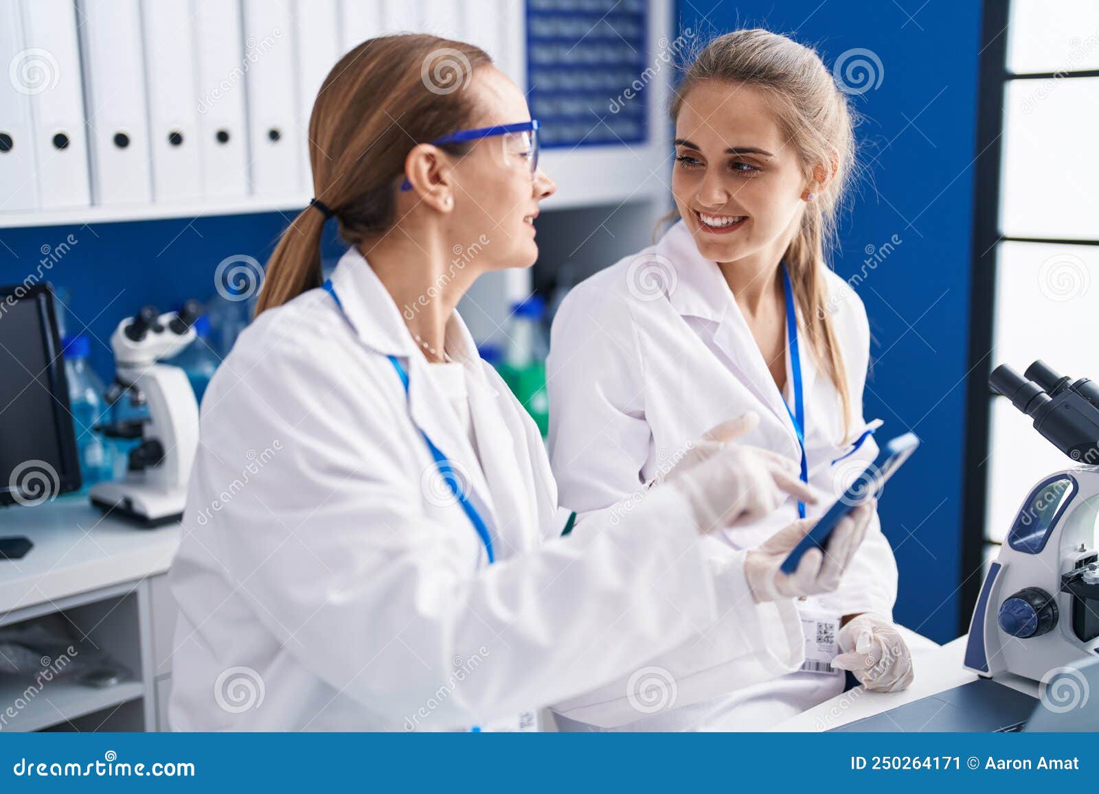 Two Women Scientists Using Smartphone Working at Laboratory Stock Image ...