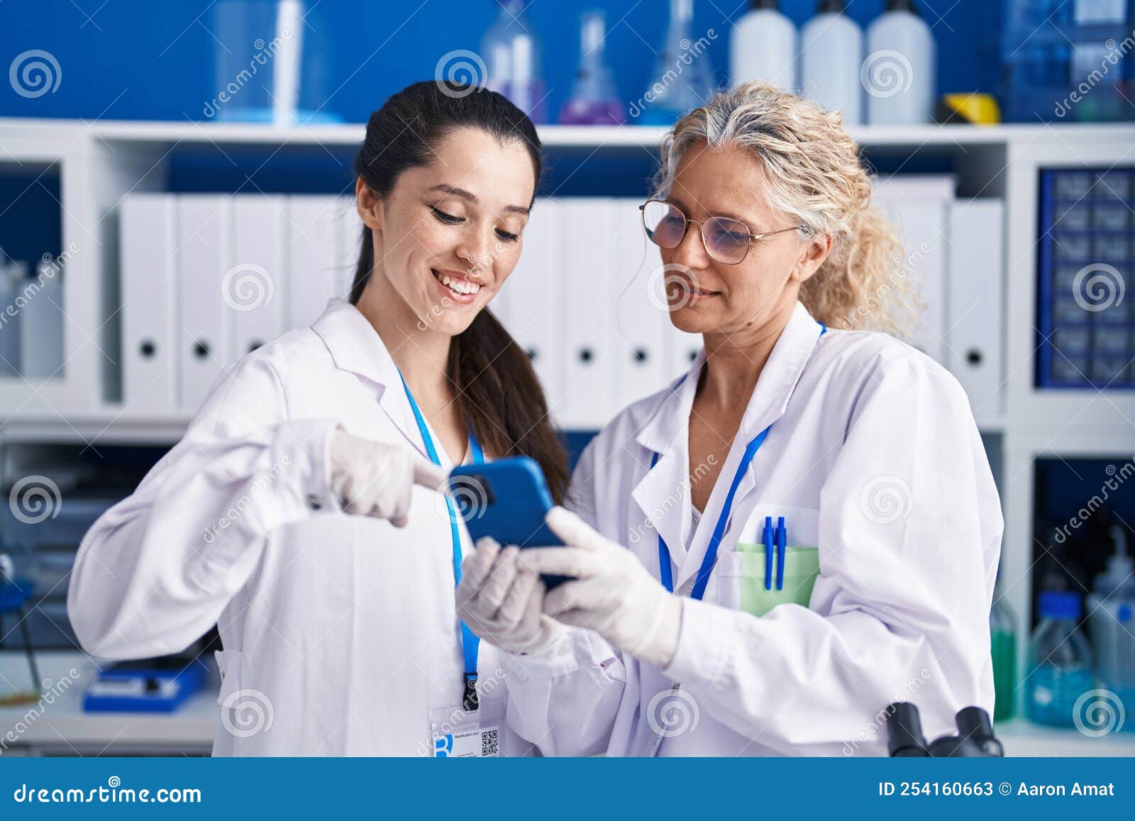 Two Women Scientists Using Smartphone Working at Laboratory Stock Image ...