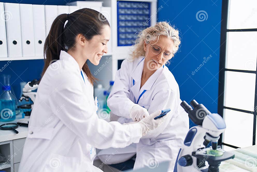 Two Women Scientists Using Smartphone Working at Laboratory Stock Photo ...