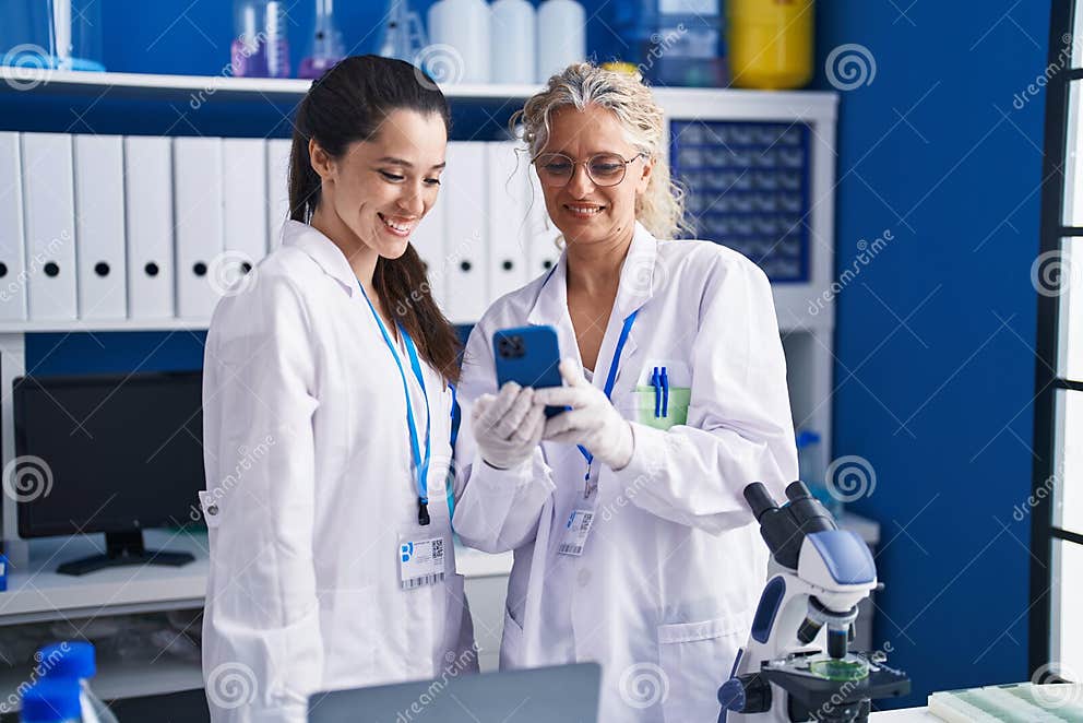Two Women Scientists Using Smartphone Working at Laboratory Stock Image ...