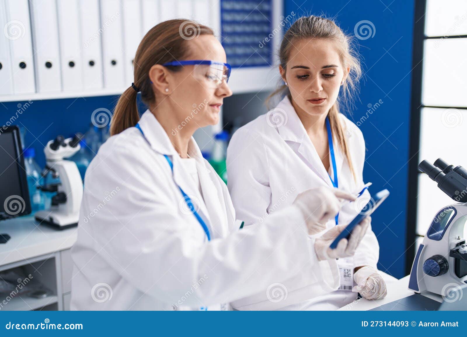 Two Women Scientists Using Smartphone Working at Laboratory Stock Image ...