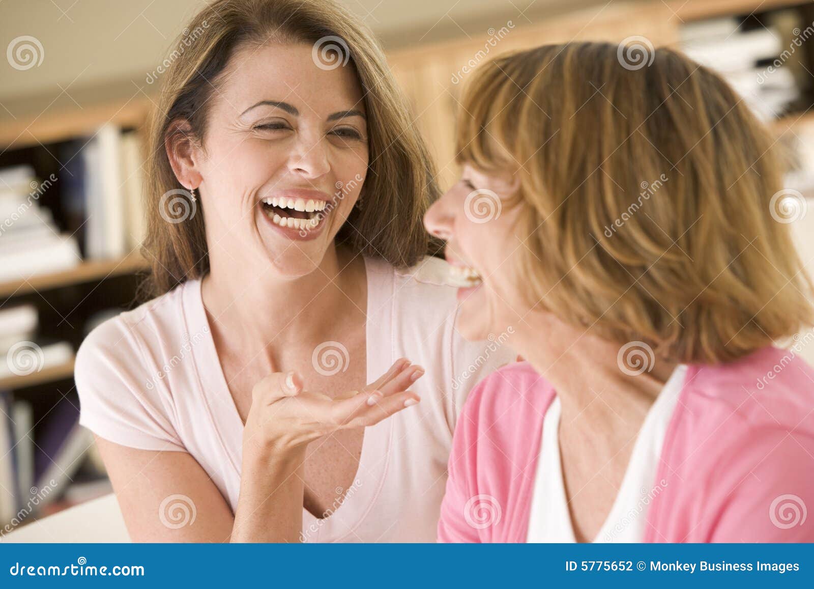 Two Women Sitting in Living Room Talking and Laugh Stock Photo - Image ...