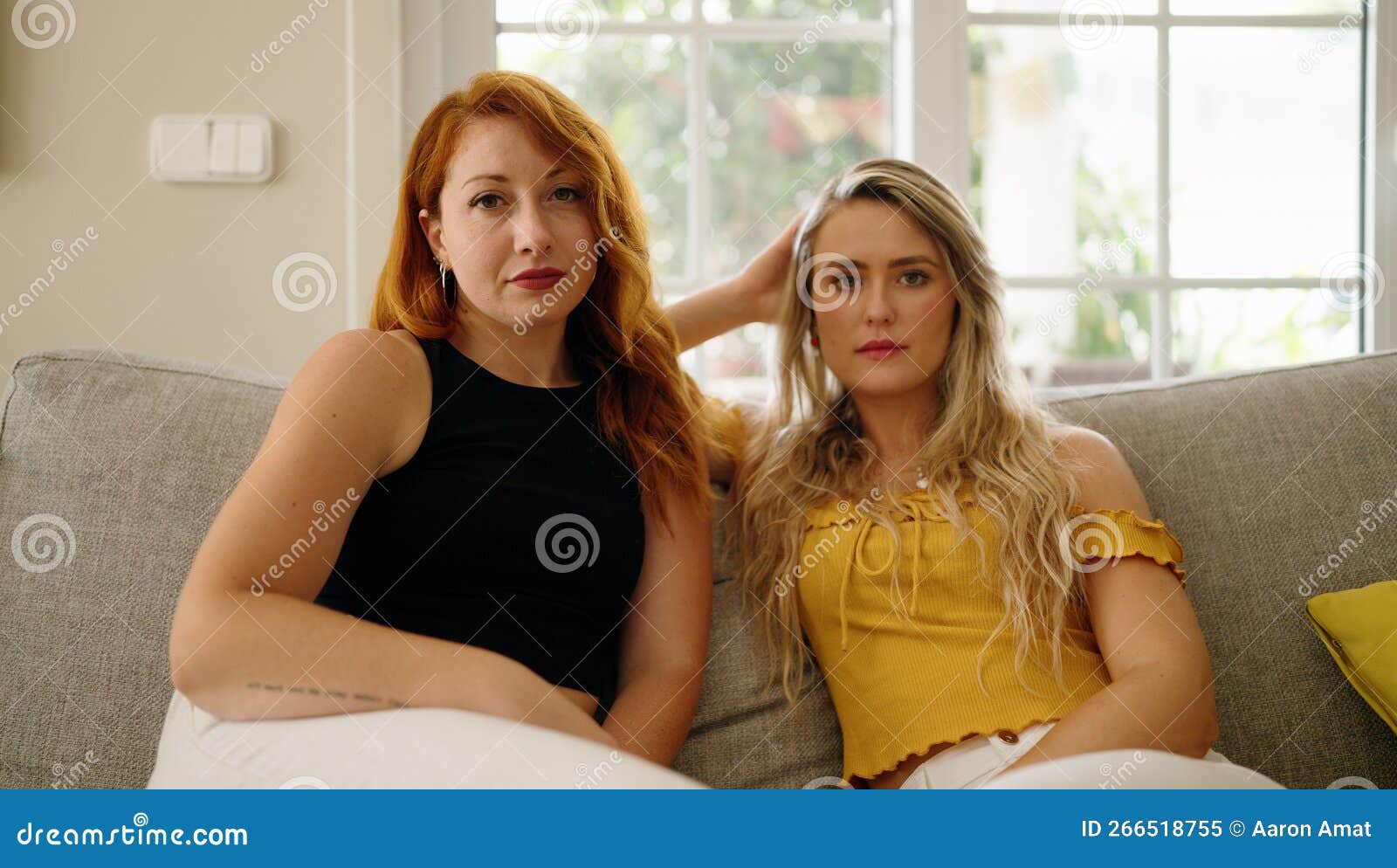 Two Women Sitting on Sofa with Serious Expression at Home Stock Image ...