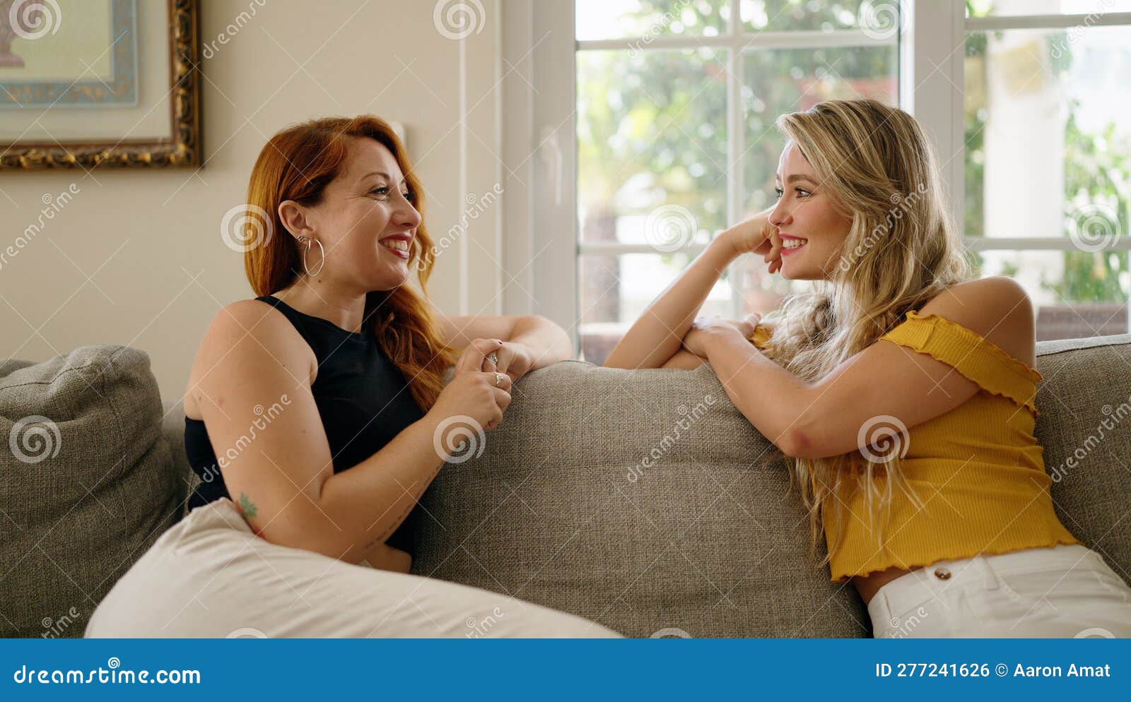 Two Women Sitting on Sofa Speaking at Home Stock Photo - Image of adult ...