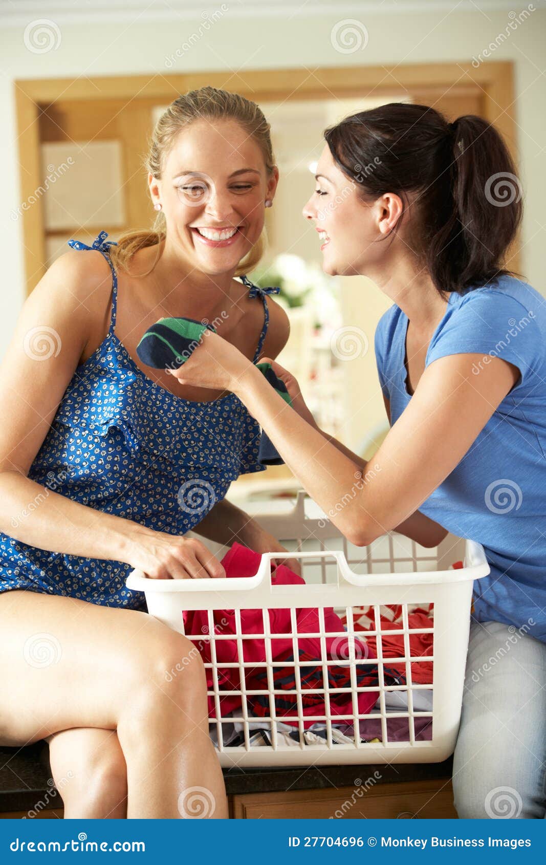 Two Women Sorting Laundry in Kitchen Stock Photo - Image of housework ...