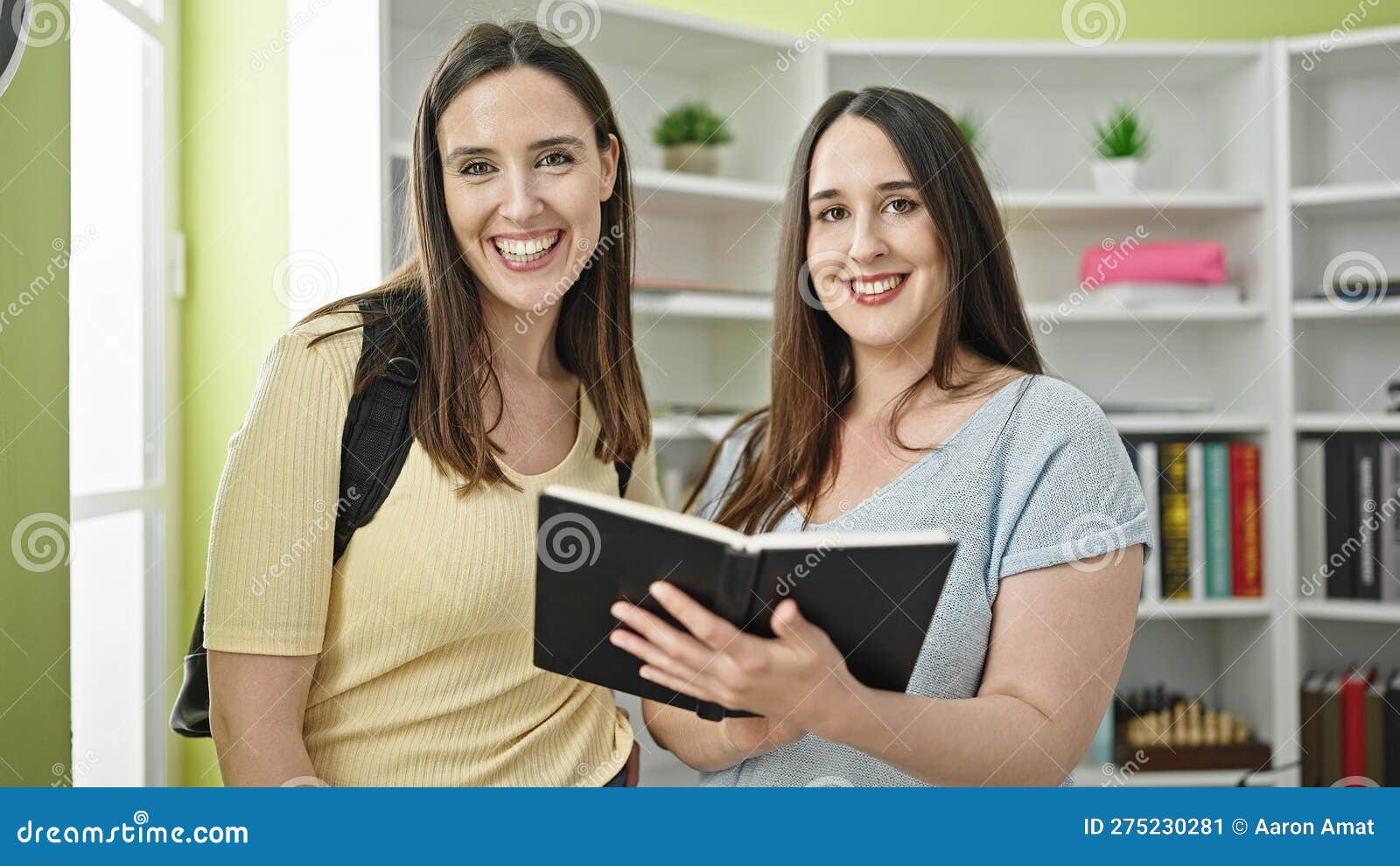 Two Women Standing Reading Book at Library University Stock Image ...