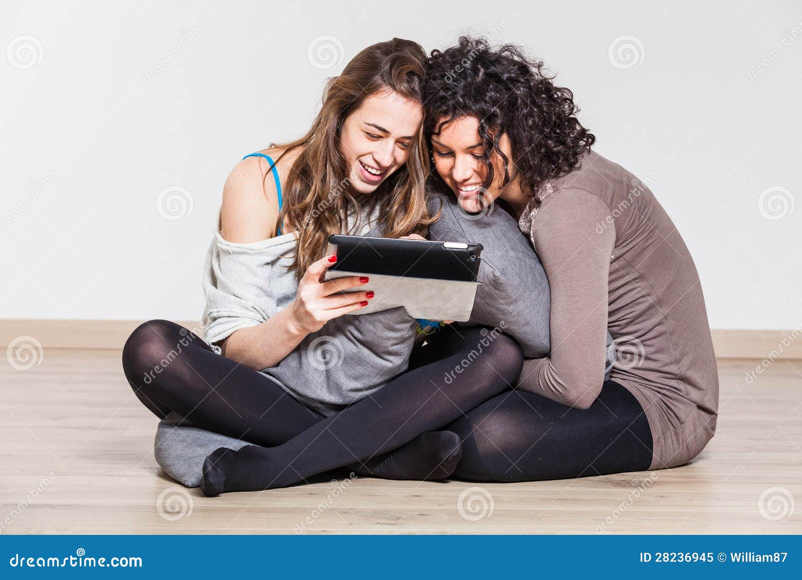 Two Women with Tablet PC stock image. Image of beauty - 28236945