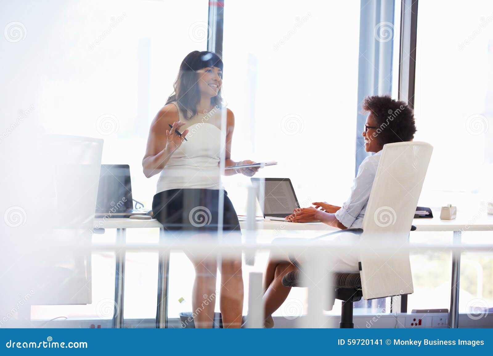 Two Women Talking in an Office Stock Image - Image of career ...