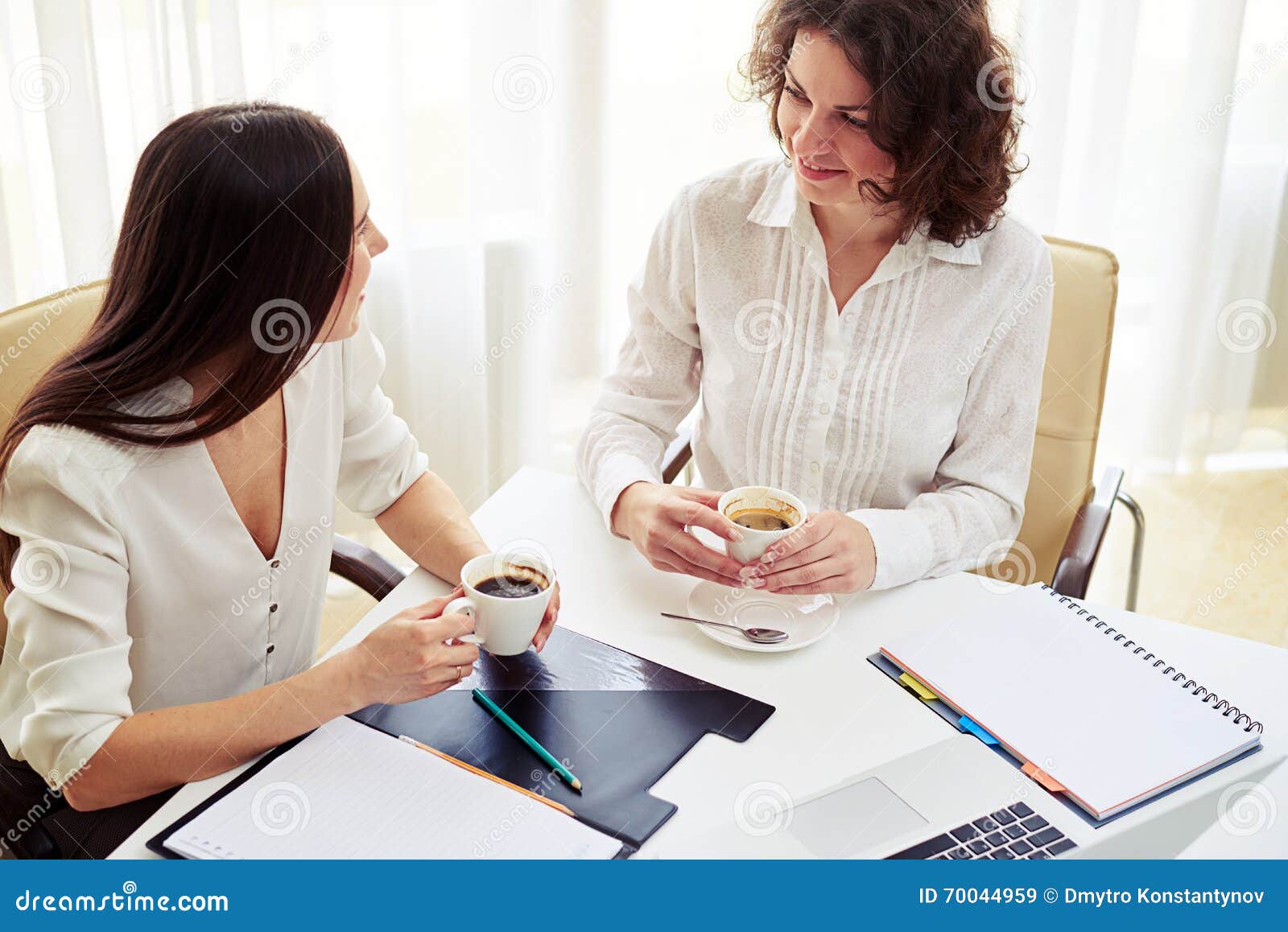 Two Women Talking about Something and Drink Coffee in the Office Stock ...