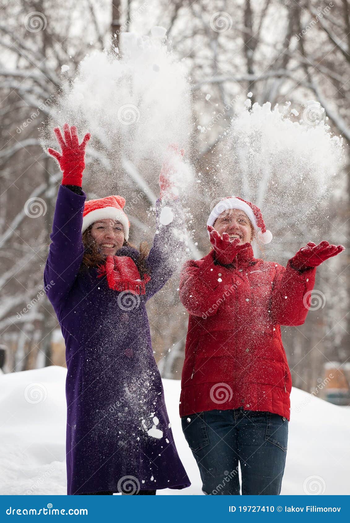 Two women throw up snow stock photo. Image of outdoors - 19727410