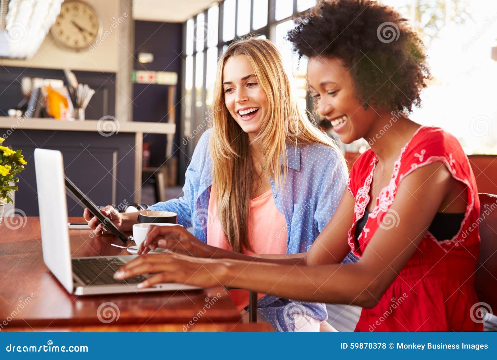 Two Women Using Computers in a Coffee Shop Stock Photo - Image of ...