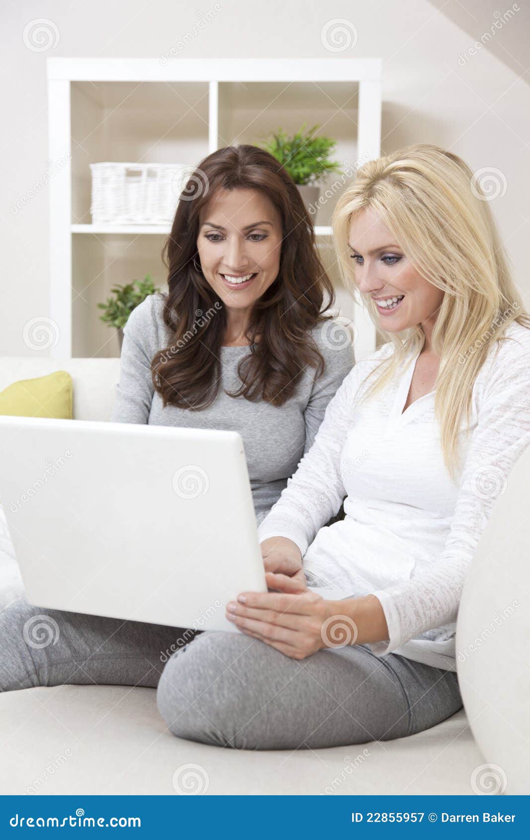 Two Women Using Laptop Computer at Home on Sofa Stock Image - Image of ...