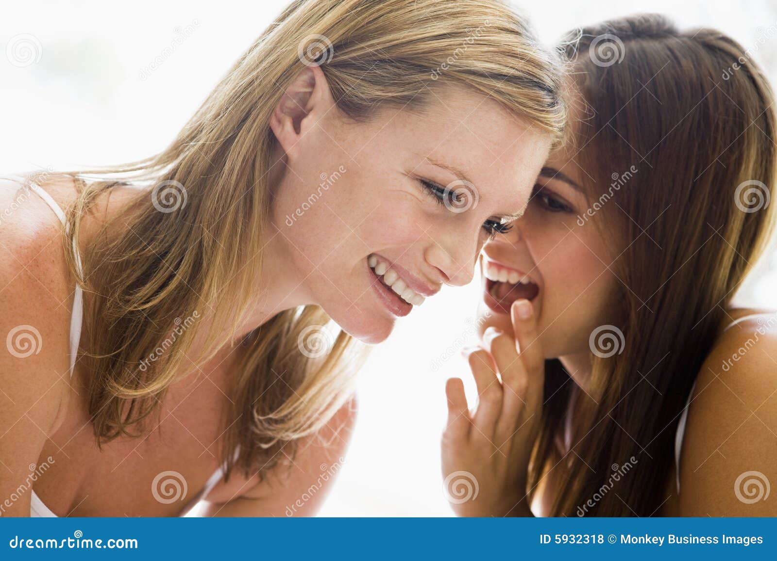 Two Women Whispering and Smiling Stock Photo - Image of sharing ...