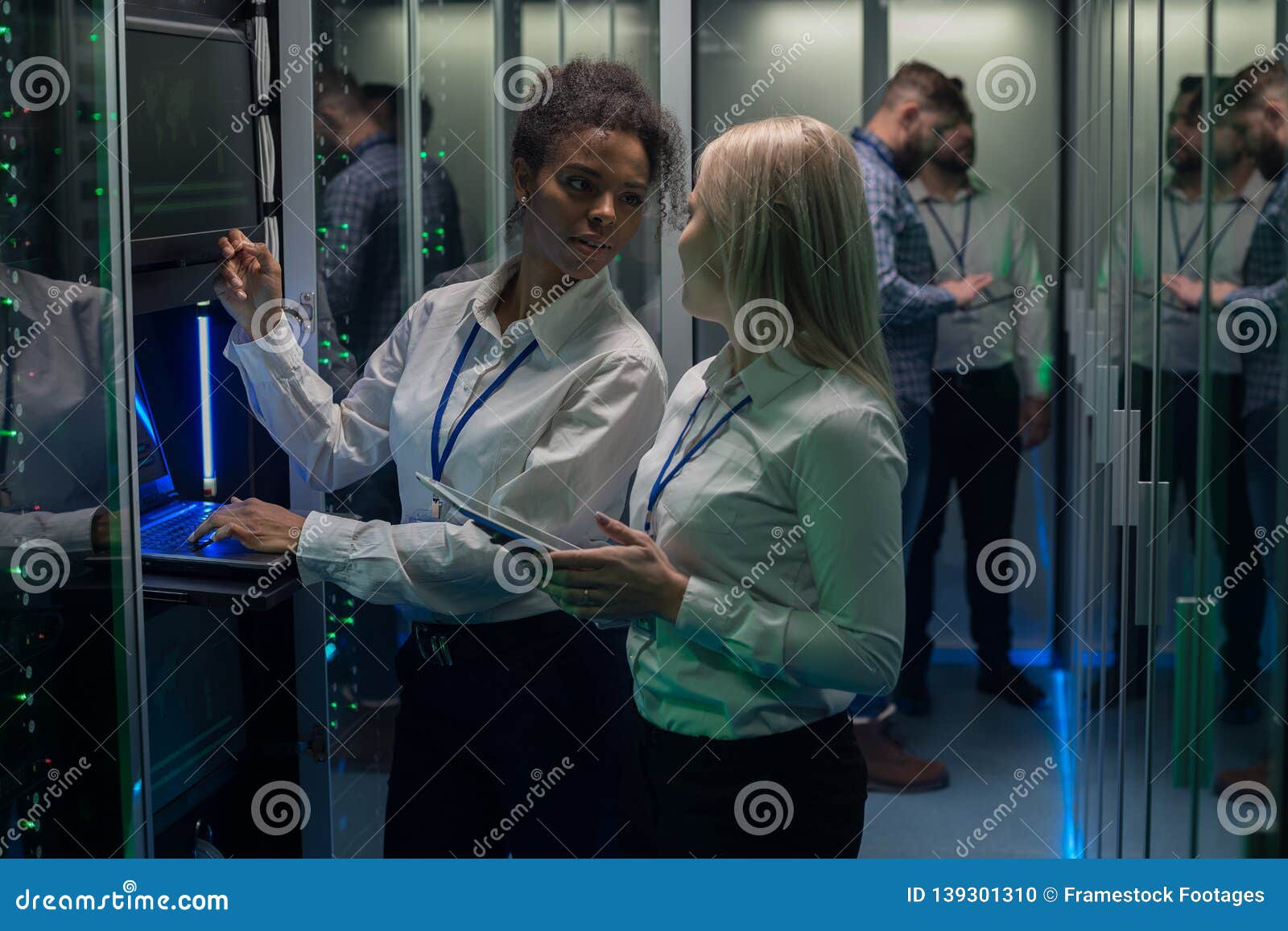 Two Women are Working in a Data Center with Rows of Server Racks Stock ...