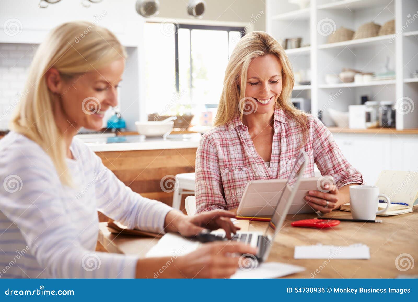 Two Women Working Together at Home Stock Photo - Image of aged, middle ...