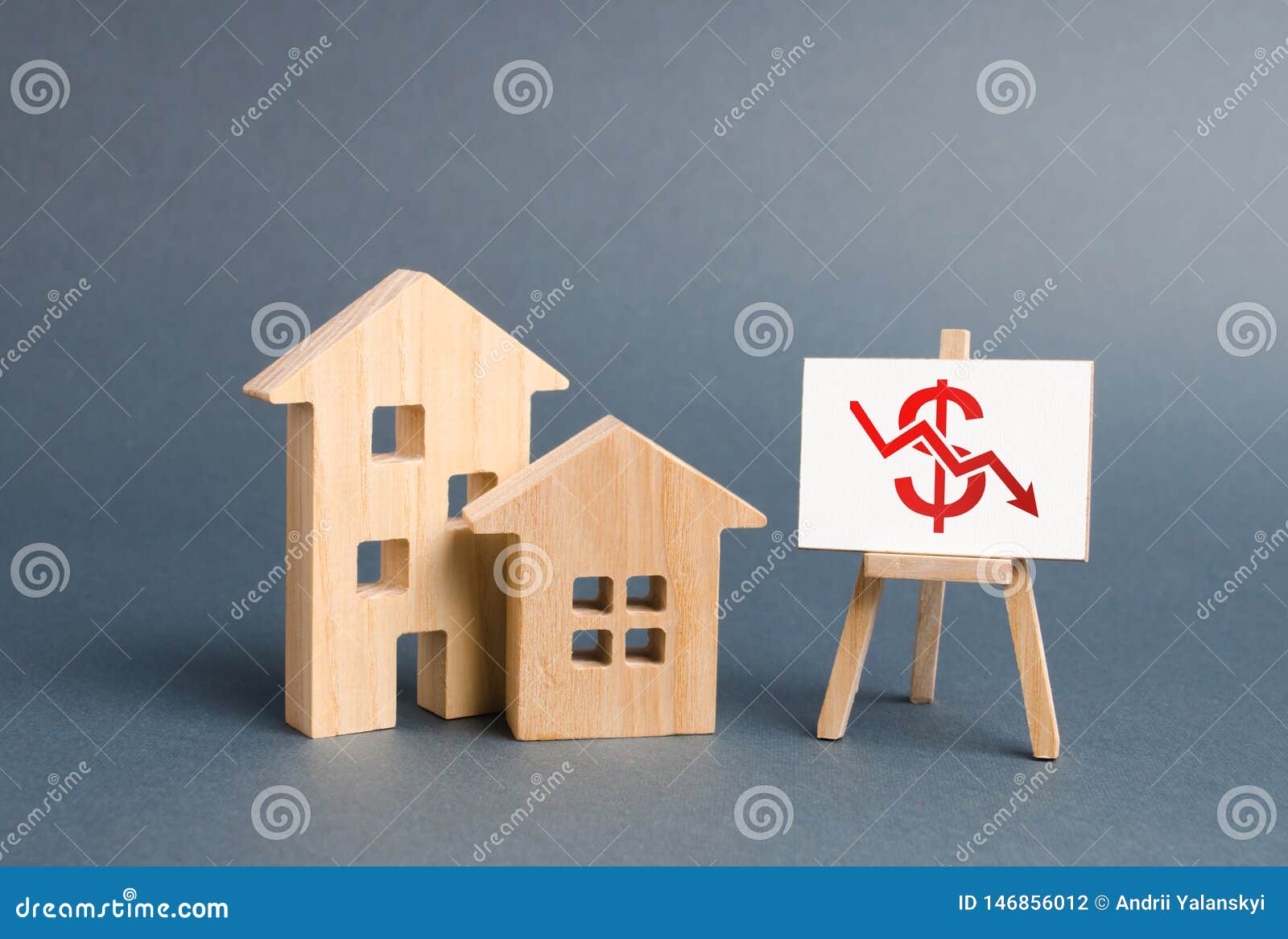 Two Wooden Houses and a Poster with a Symbol of Falling Value. Concept ...