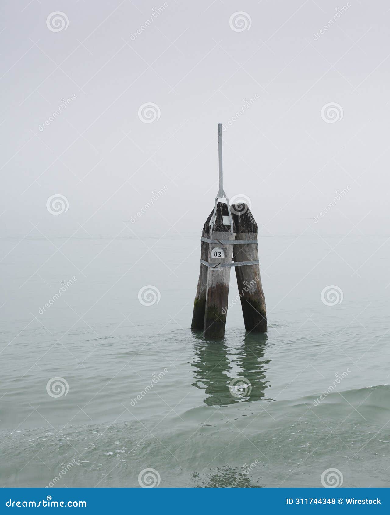 Two Wooden Poles Protruding from the Ocean. Stock Photo - Image of ...