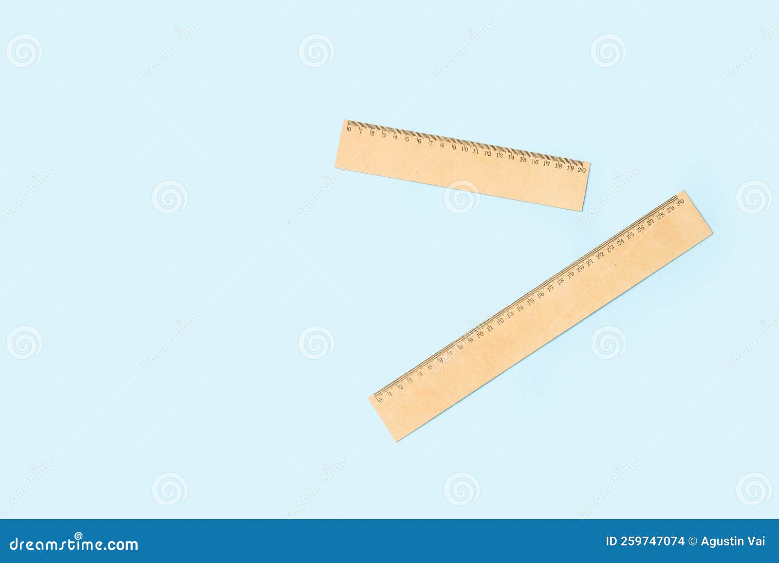Two Wooden Rulers on a Light Blue Background Stock Photo - Image of ...