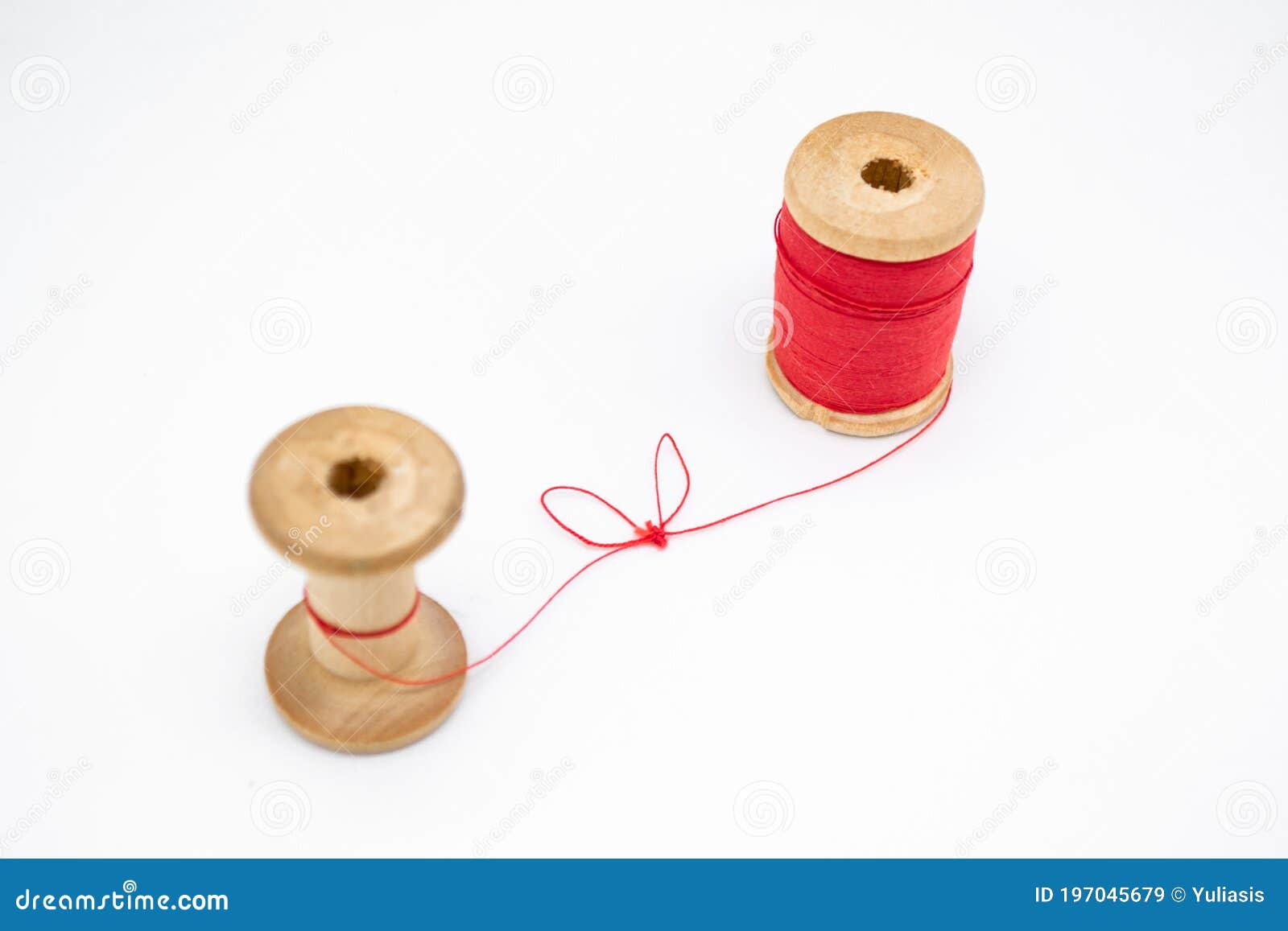Two Wooden Spools of Thread. One is Full, the Other almost Empty ...