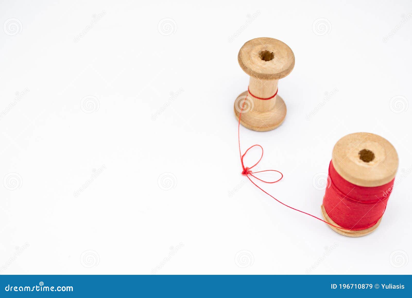 Two Wooden Spools of Thread. One is Full, the Other almost Empty ...