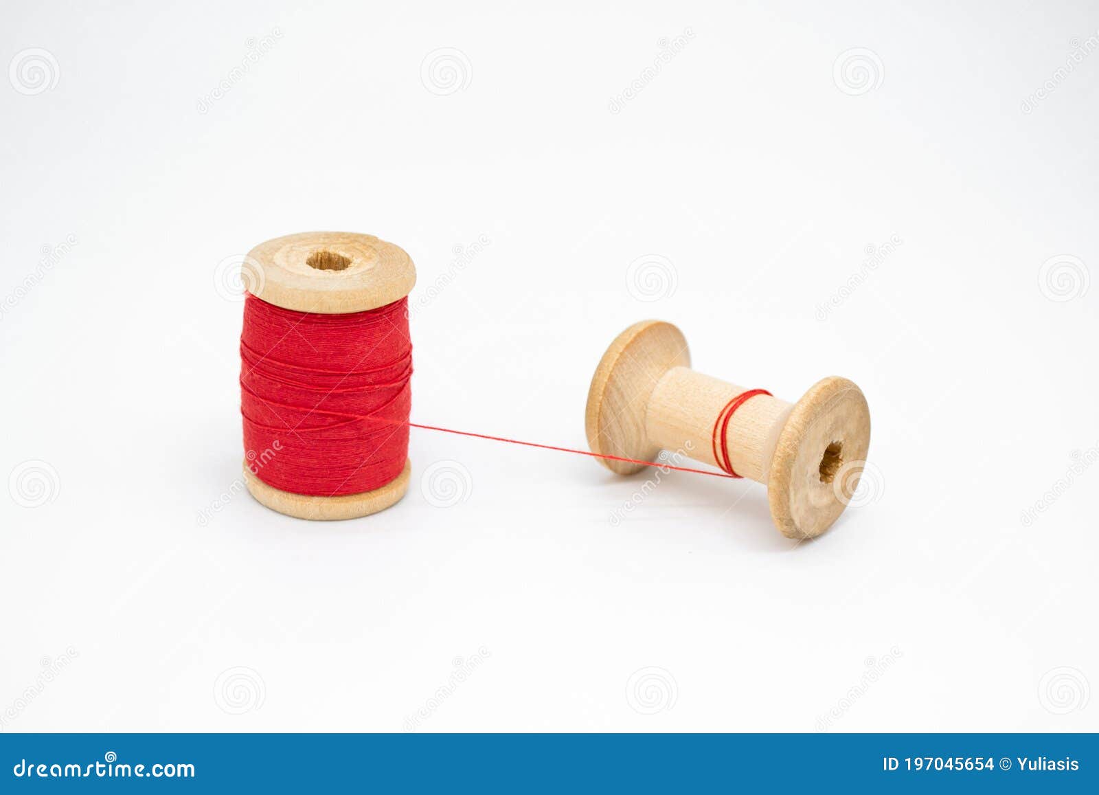 Two Wooden Spools of Thread. One is Full, the Other almost Empty ...