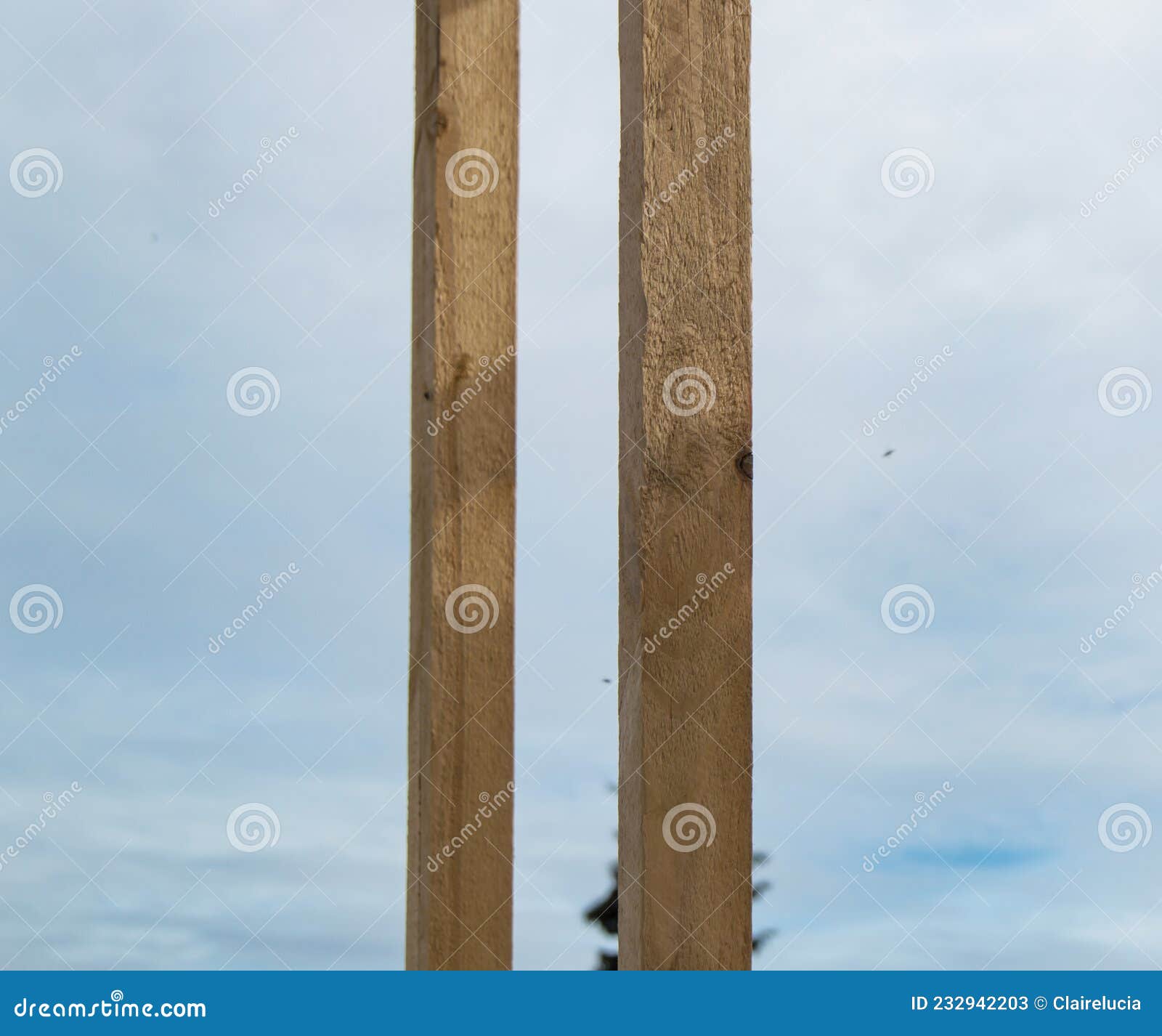 Two Wooden Vertical Beams on a Blue Sky Background Stock Image - Image ...