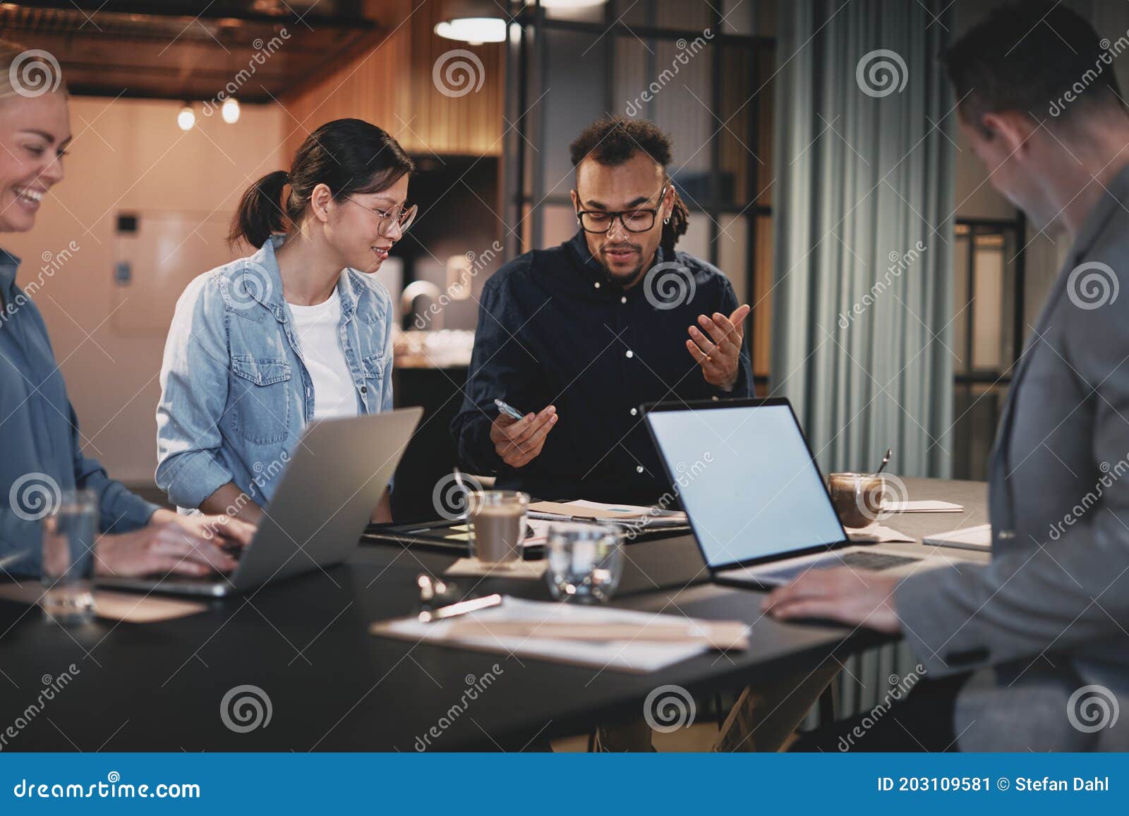 Two Work Colleagues Talking Together Around an Office Table Stock Image ... Two Work Colleagues Talking Together Around an Office Table Stock Image ...