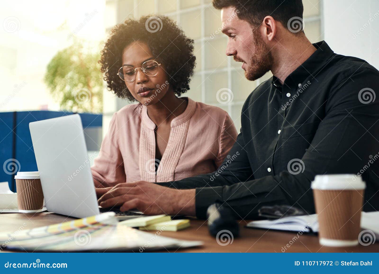 Focused Colleagues Working Online Together at an Office Desk Stock ...