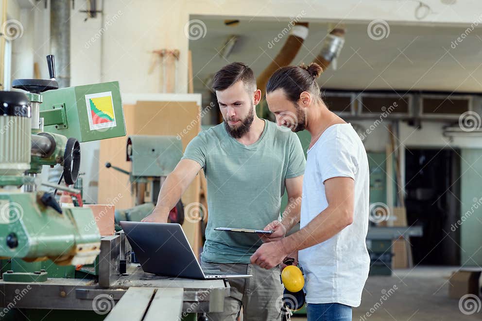 Two Worker in a Carpenter`s Workshop with Computer and Clipboard Stock ...