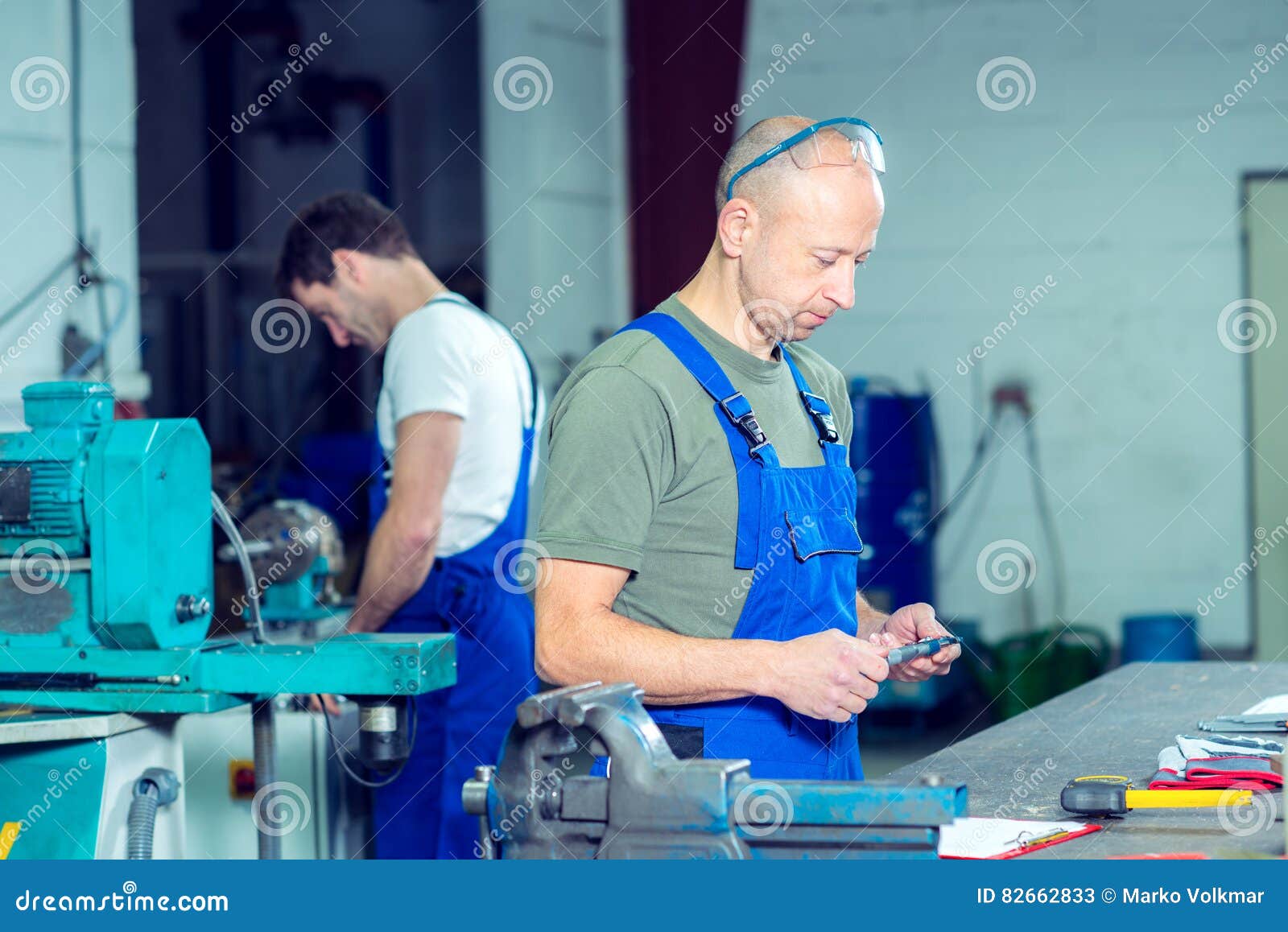 Two worker in factory stock image. Image of bench, helmet - 82662833