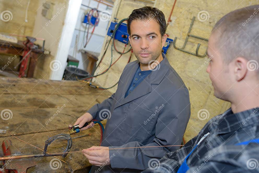Two Worker in Factory on Work Bench in Conversation Stock Photo - Image ...