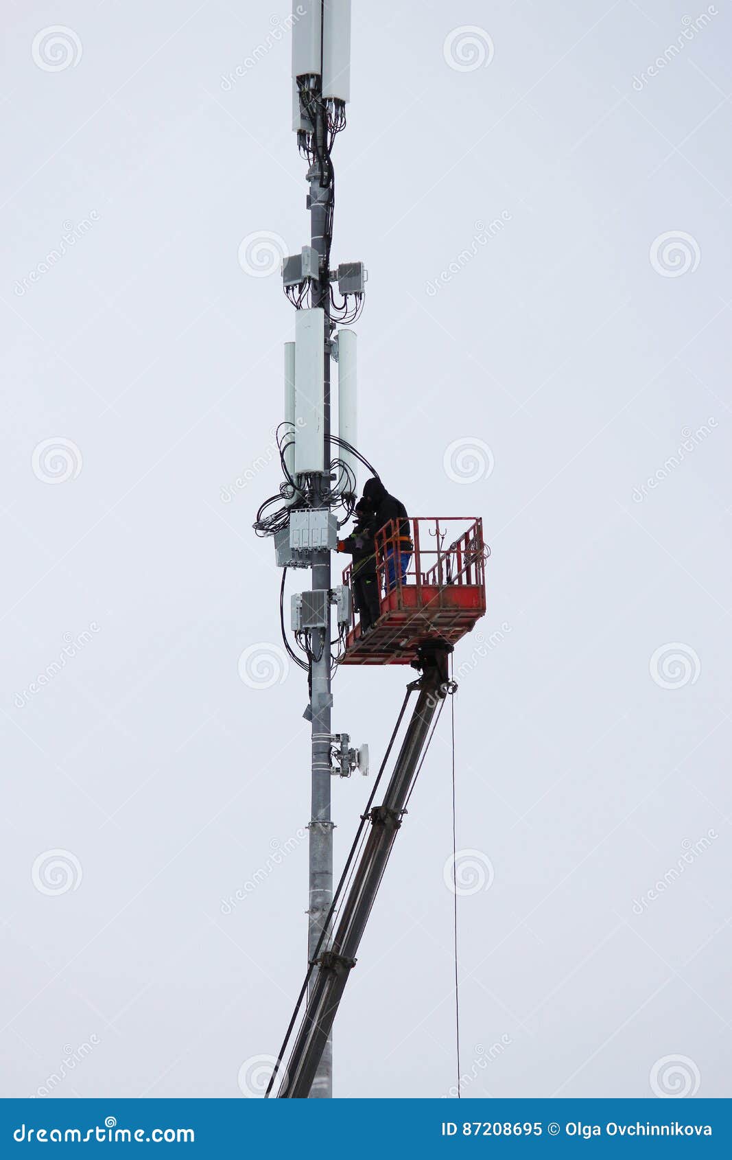 Two Workers Assemble Equipment for Telecommunications on the Tower with ...