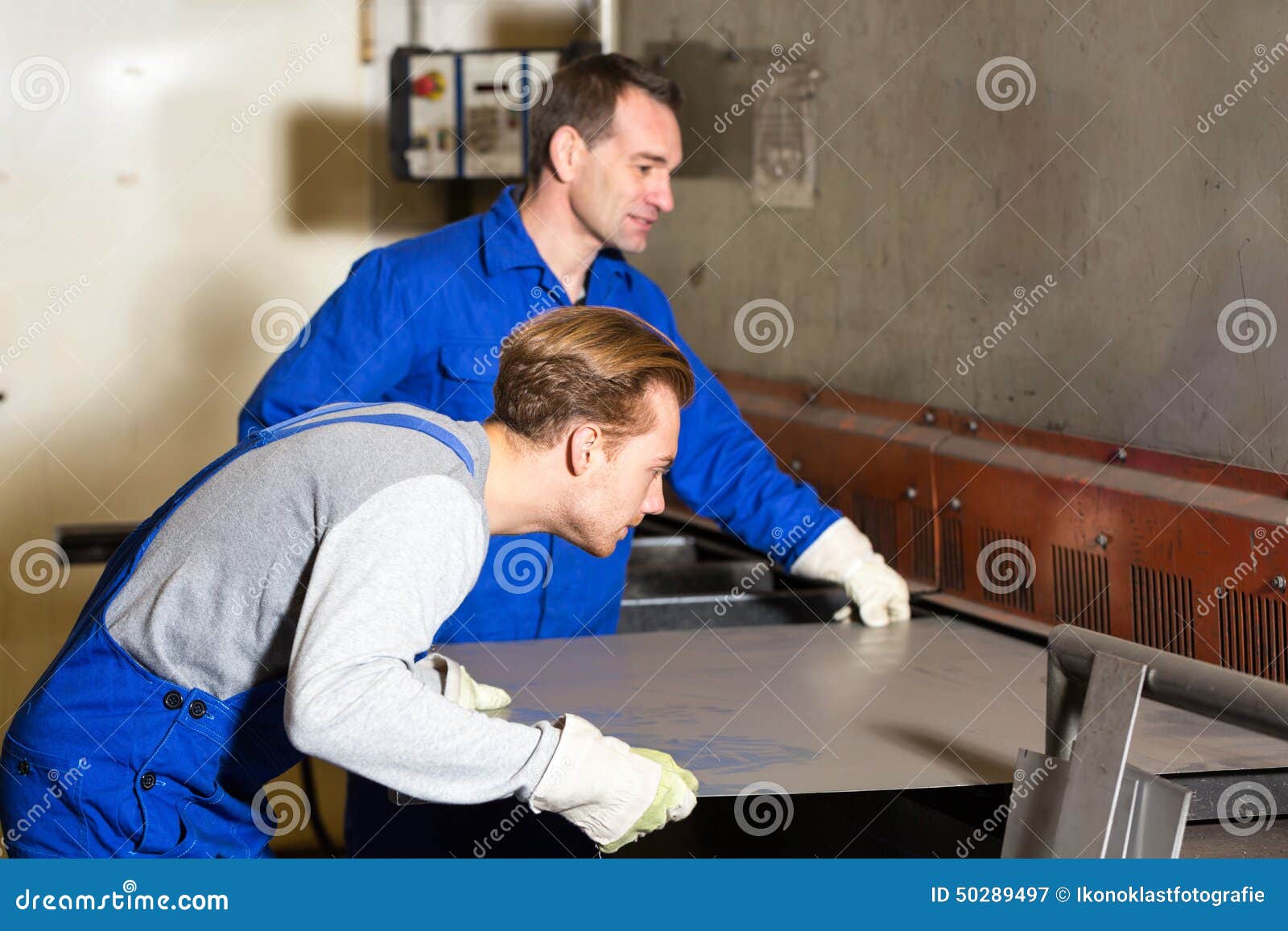 Two Workers Bending Sheet Metal with Large Machine Stock Image - Image ...