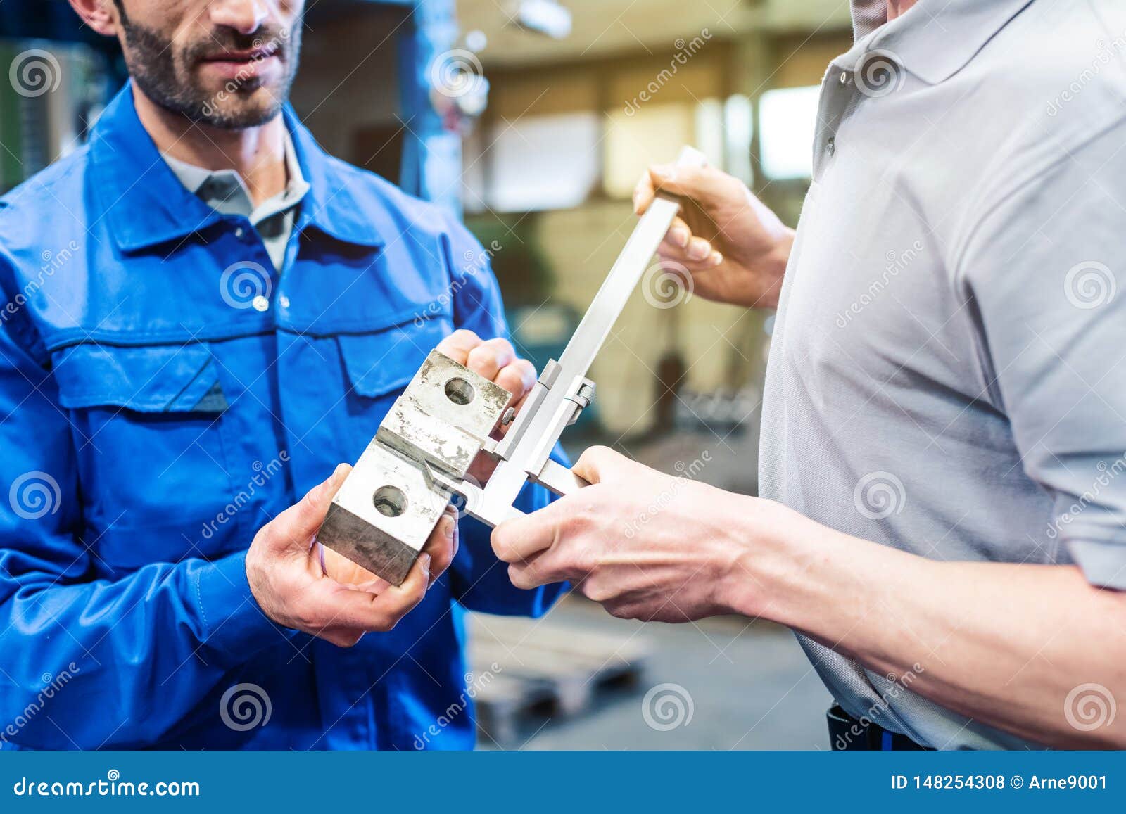 Two Workers Checking Measurements of Work Piece in the Factory Stock ...