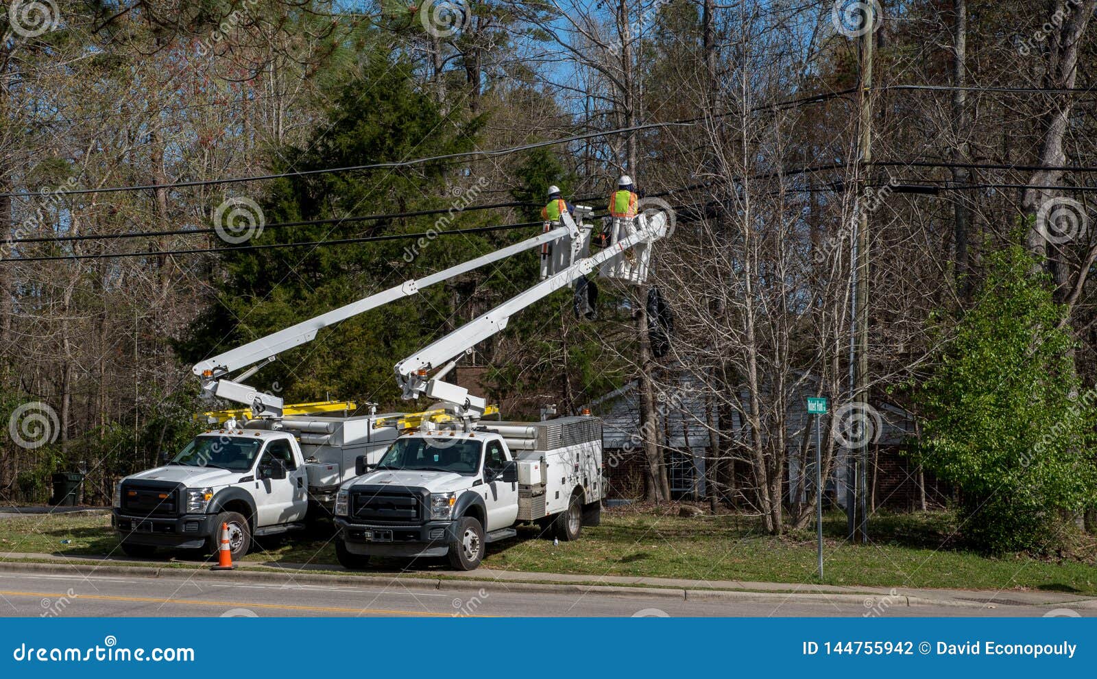 Two Workers On Two Cherry Pickers Install A Prefab Concrete Slab ...