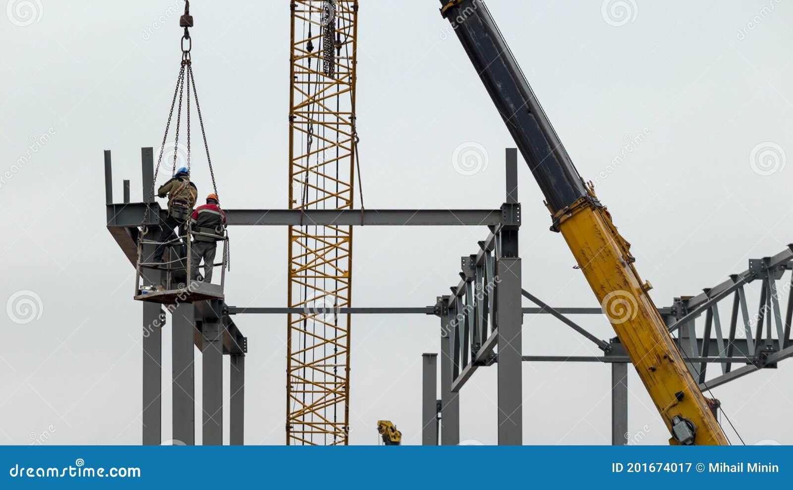 Two Workers at a Construction Site are Assembling the Frame of a ...