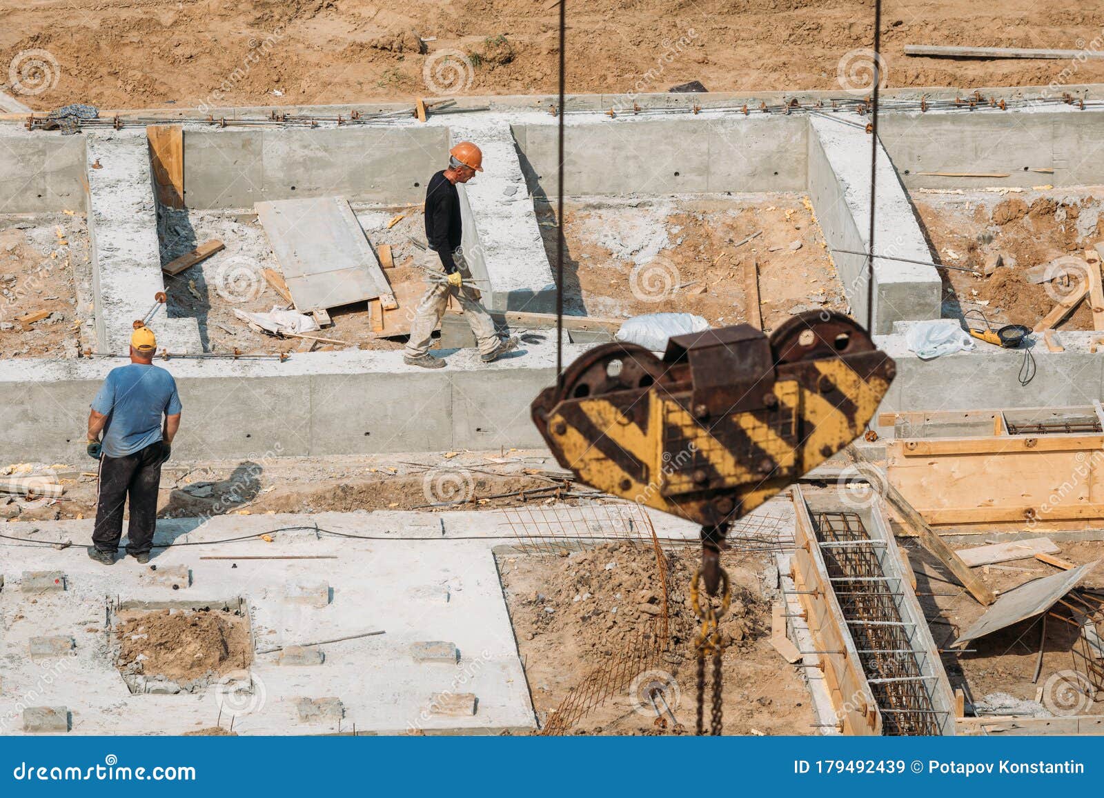 Two Workers at a Construction Site during the Installation of the First ...