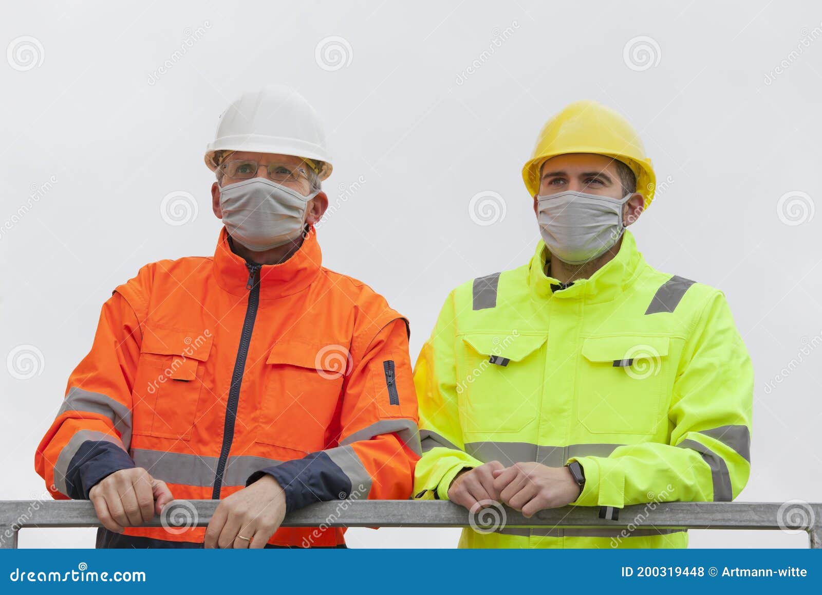 Two Workers or Engineers with Face Mask Standing on a Construction Site ...