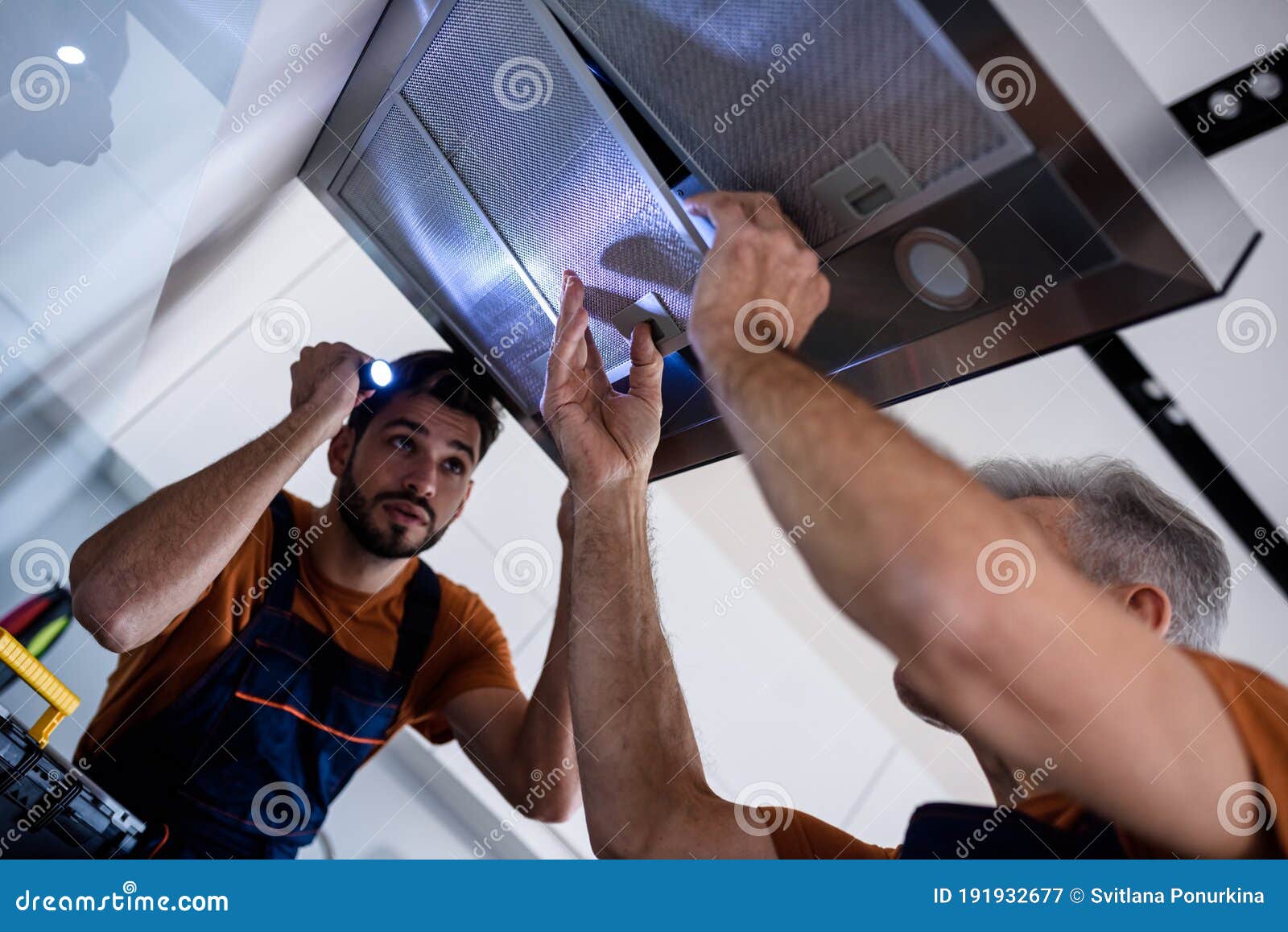 Two Workers, Handyman in Uniform Installing or Repairing a Kitchen ...