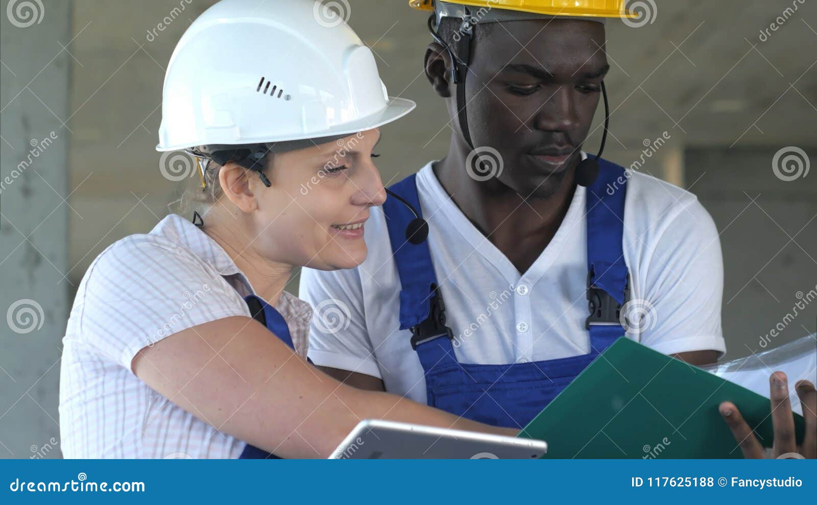 Two Workers Having Conversation and Using Tablet Computer Stock Photo ...