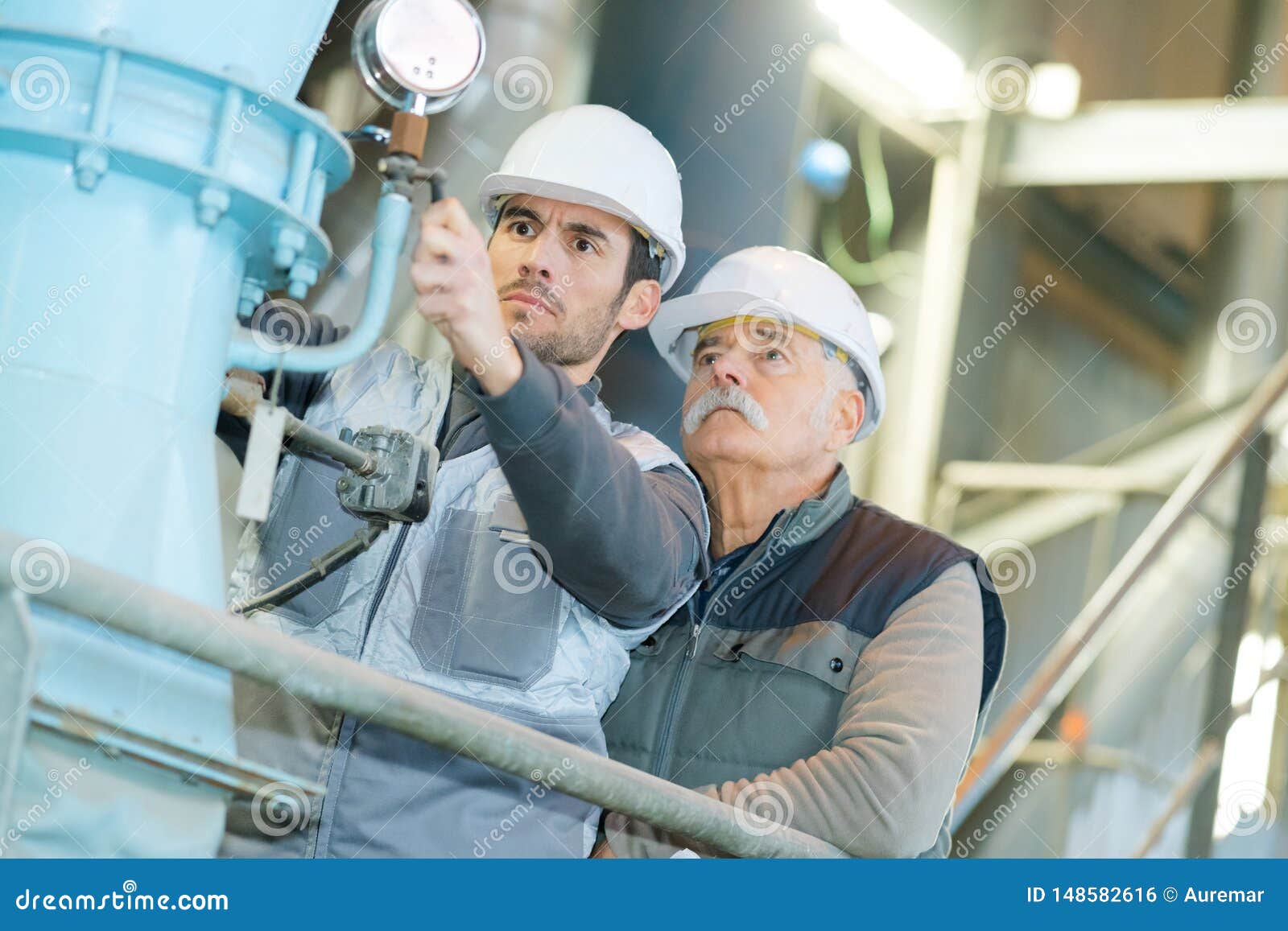 Two Workers Inspecting Pressure Valves on Tank Stock Photo - Image of ...