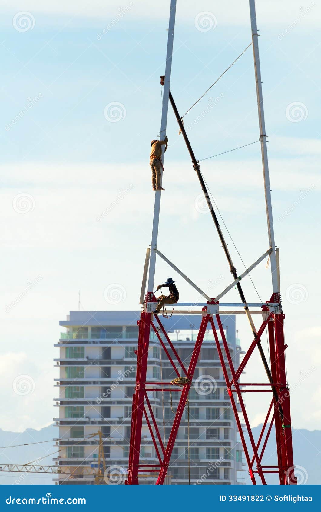 Two Workers Install a Lot of Metal Tiered Tower. Stock Photo - Image of ...