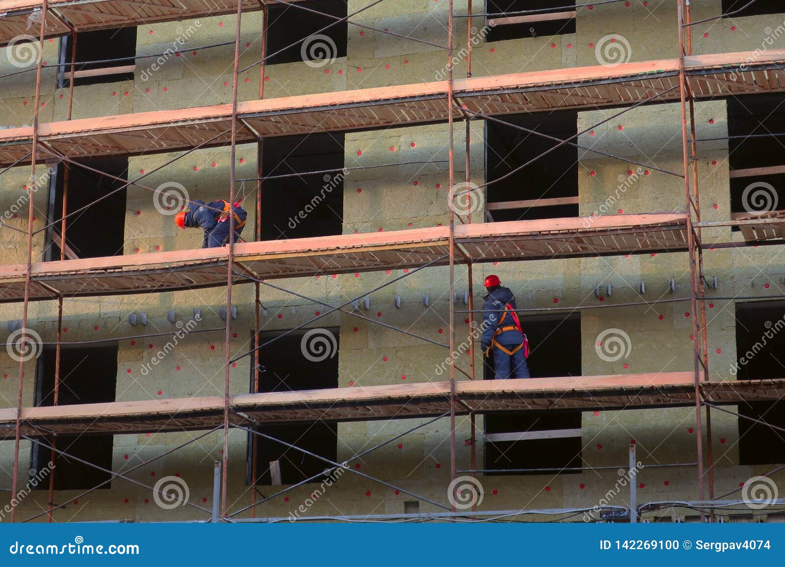 Two Workers Install Insulation on the Wall of the New Building Stock ...
