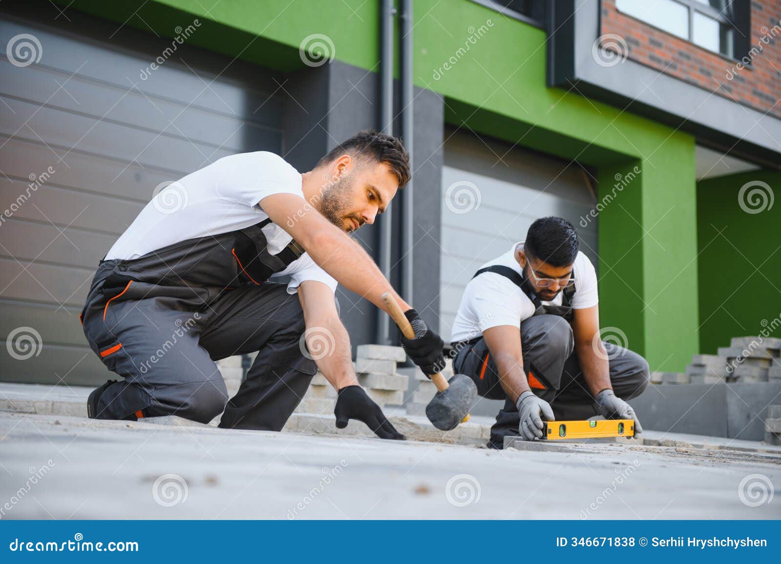 Two Workers are Laying Paving Stones Near the House Stock Photo - Image ...