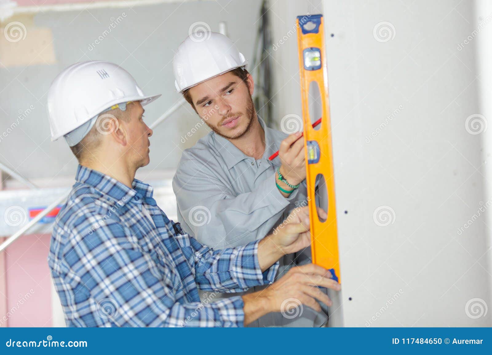 Two Workers with Level Indoors Stock Photo - Image of laborer ...