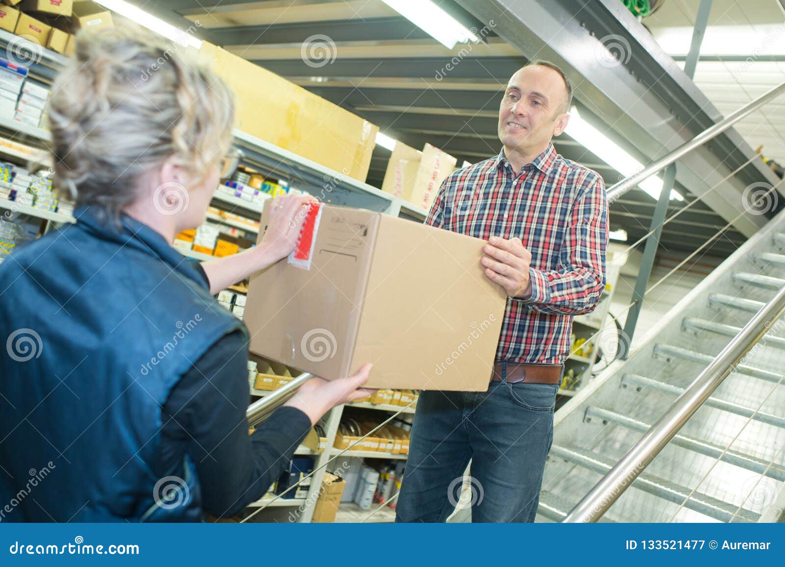 Two Workers Lifting Cardboard Box at Warehouse Stock Image - Image of ...