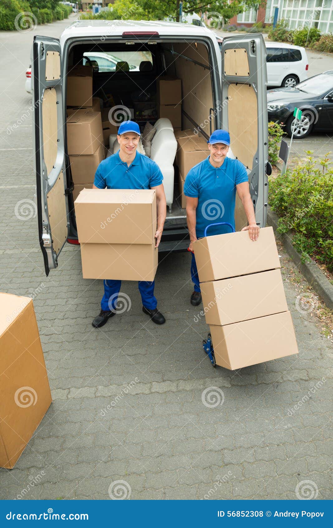 Two Workers Loading Cardboard Boxes in Truck Stock Photo - Image of ...