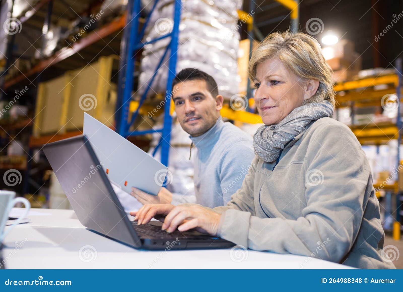 Two Workers Looking at Laptop in Warehouse Stock Photo - Image of ...
