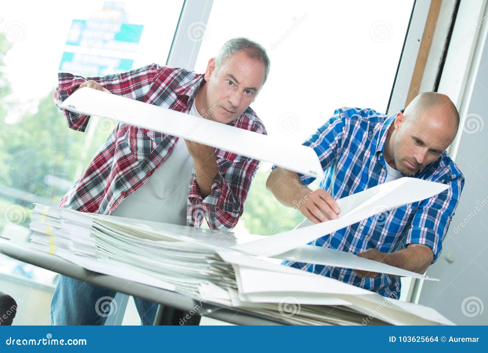Two Workers Looking through Stack Papers Stock Photo - Image of stack ...