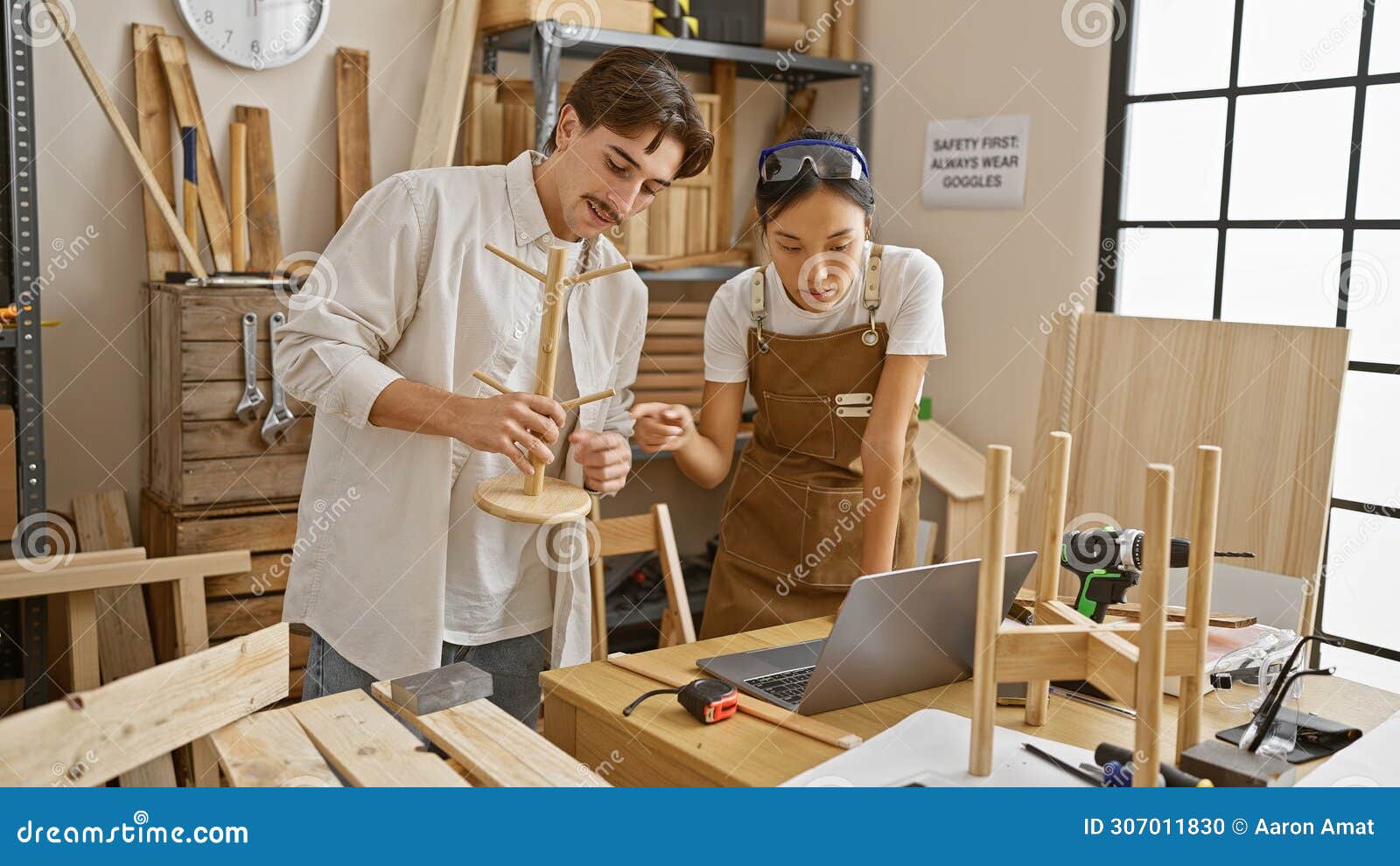 Two Workers, a Man and a Woman, Collaborate in a Workshop with ...